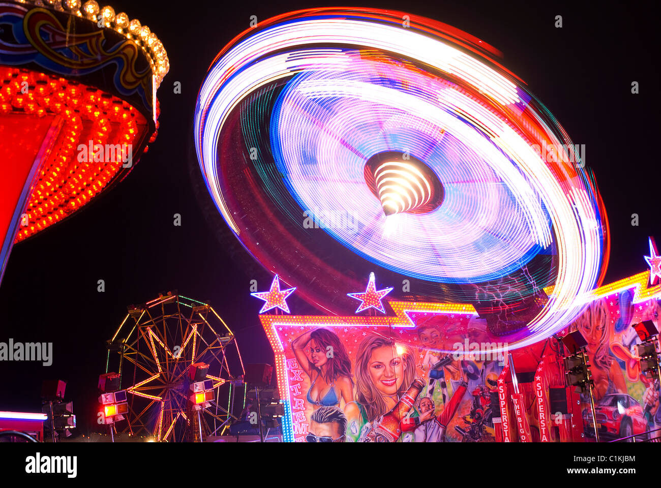 Colorful fairground ride at night at the Great Dorset Steam Fair Stock ...