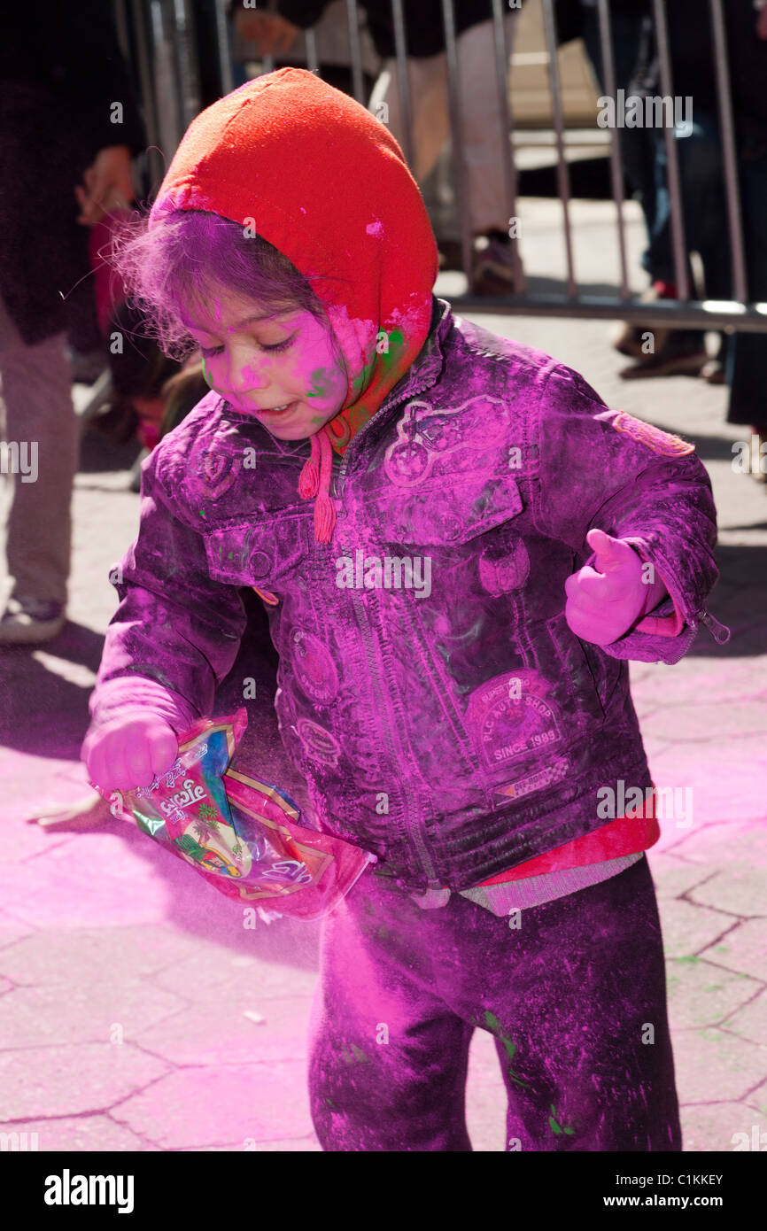 Colored powder is applied to the faces of participants as they ...