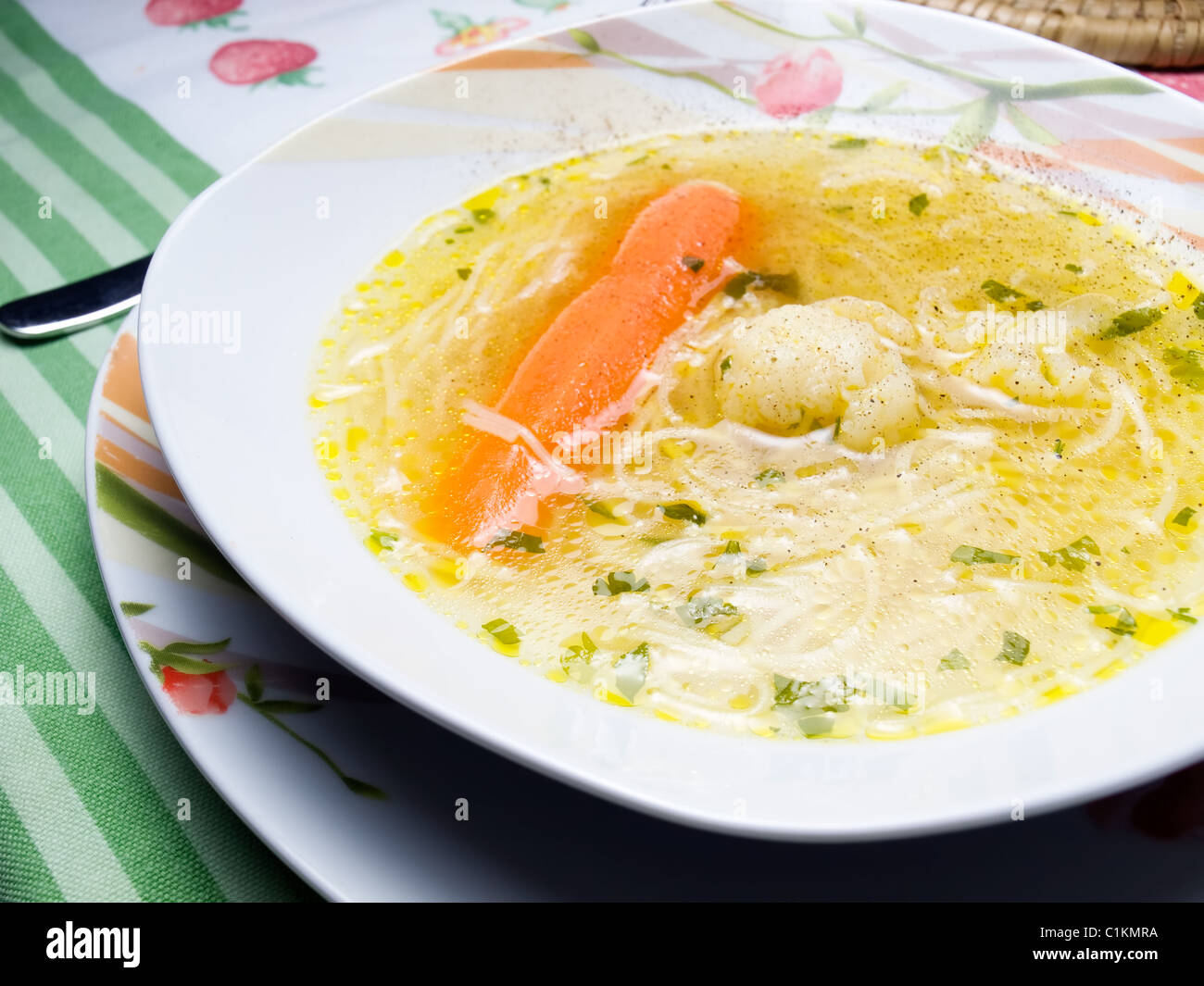 Closeup view of a clear soup with vegetables on the table Stock Photo ...