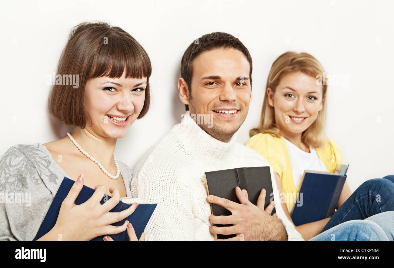 Three students holding books hi-res stock photography and images - Alamy