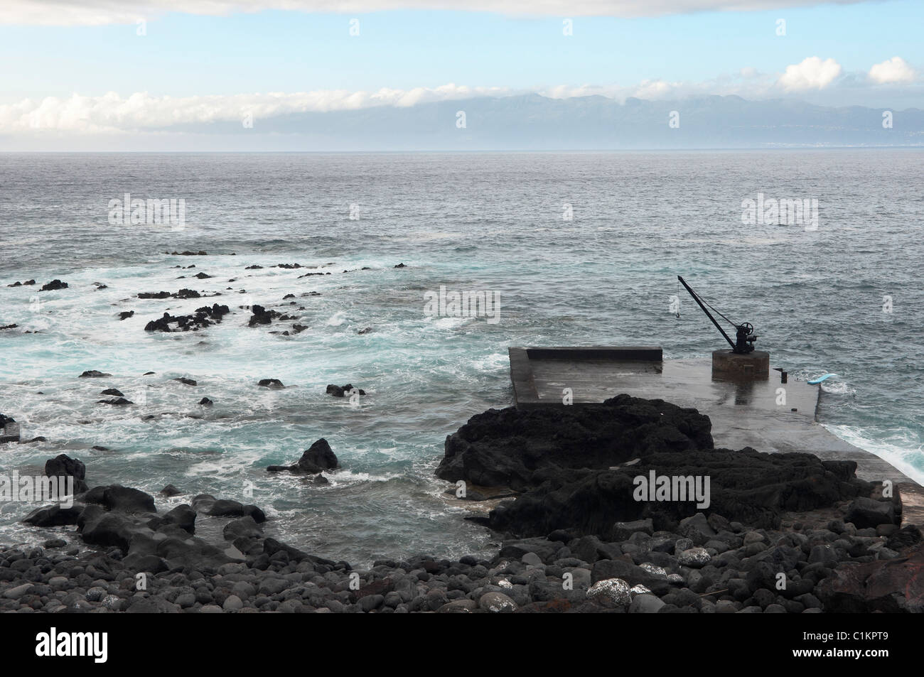 Small quay in the rocky volcanic north coast of Pico island, Azores ...