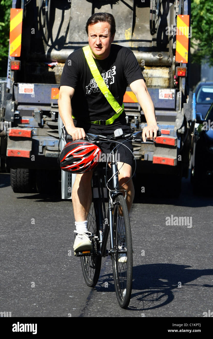 David Cameron jumps on his bike without wearing his helmet after ...