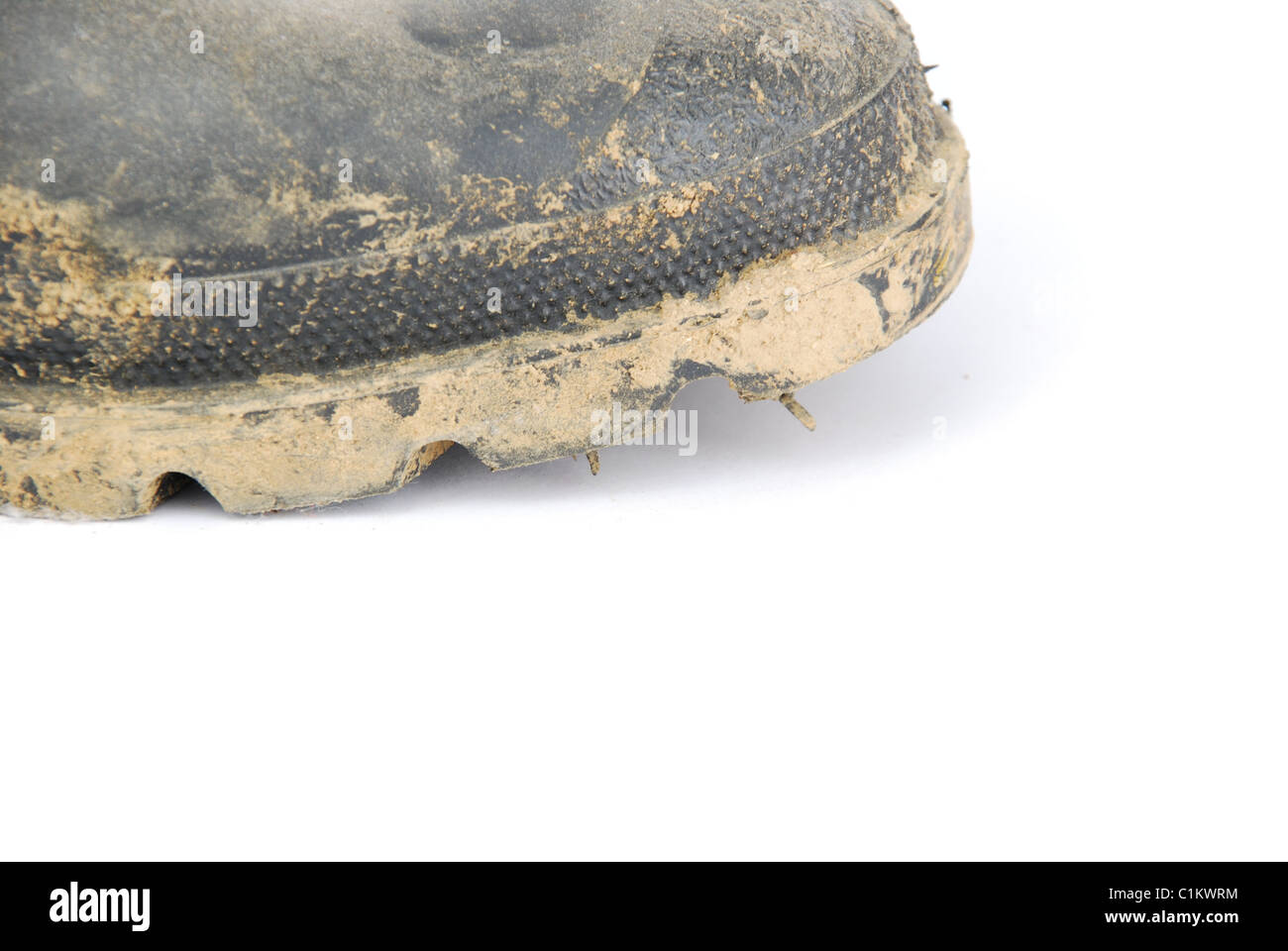 Black rubber boots and soil on white Stock Photo - Alamy
