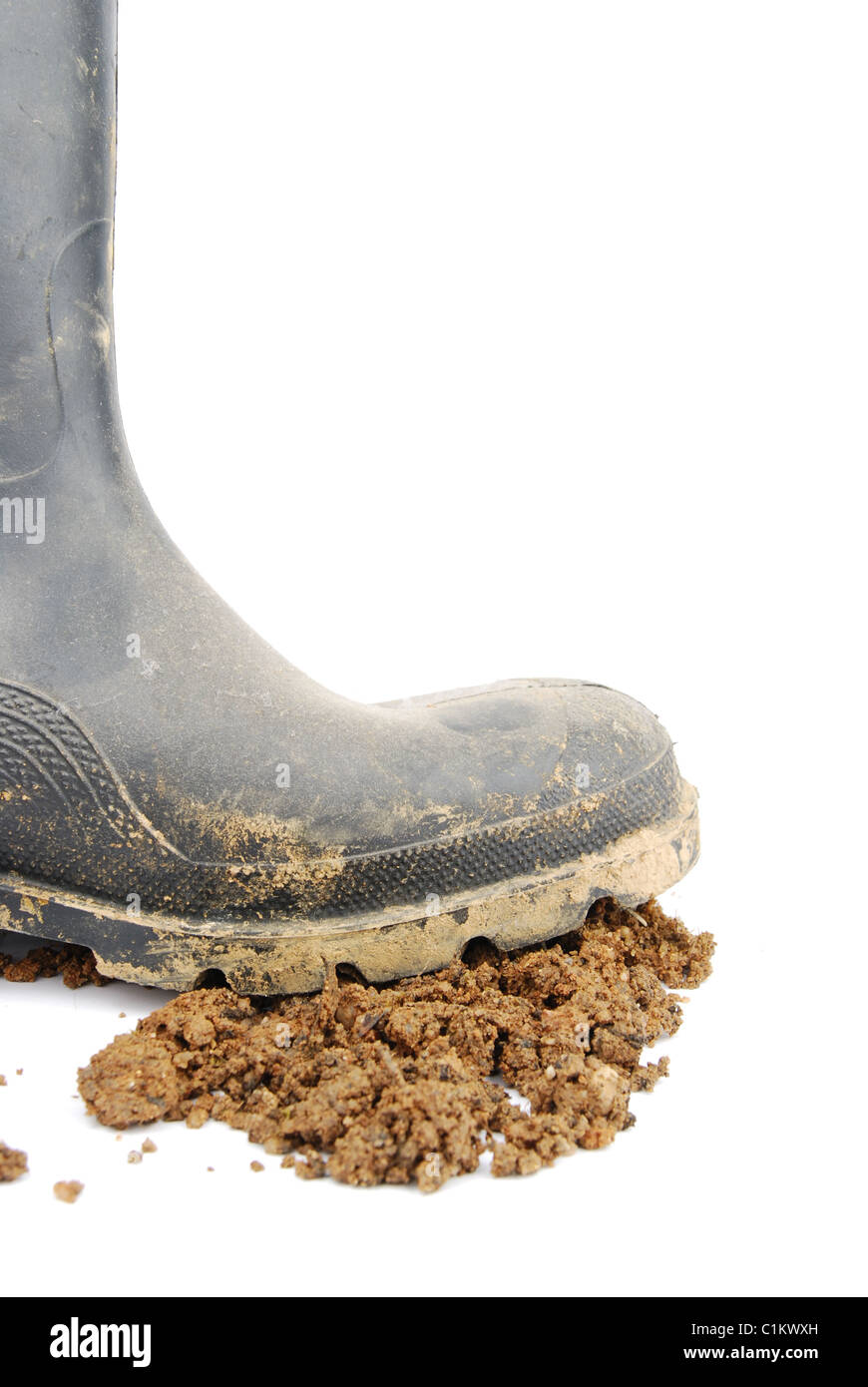 Black rubber boot and soil on white Stock Photo - Alamy