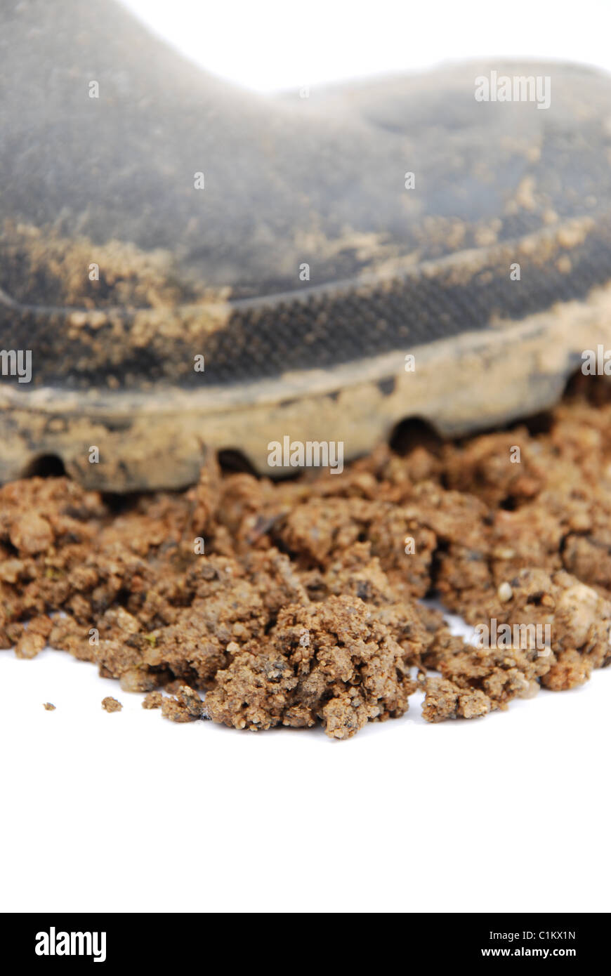 Black rubber boots and soil on white Stock Photo - Alamy