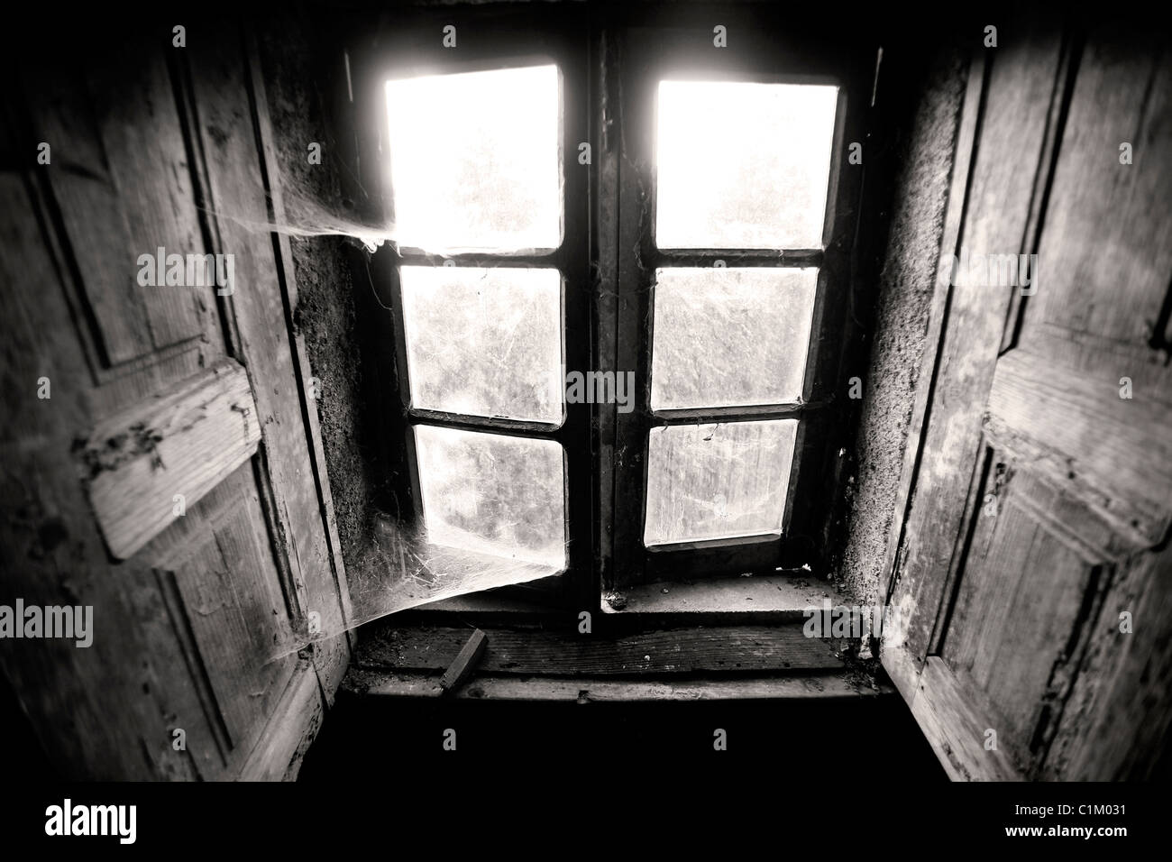 Haunted house with spider's webs at the window Stock Photo - Alamy