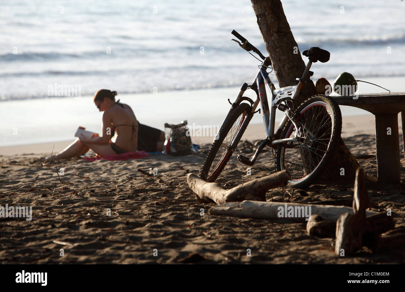 Woman reading on the beach, Playa Carillo, Nicoya Peninsula, Costa Rica ...