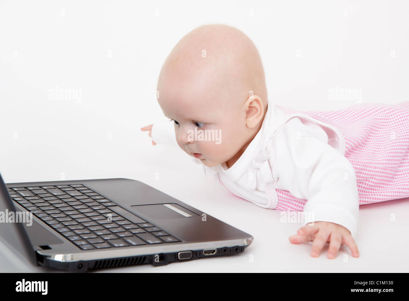 baby with laptop lying on a light background Stock Photo - Alamy