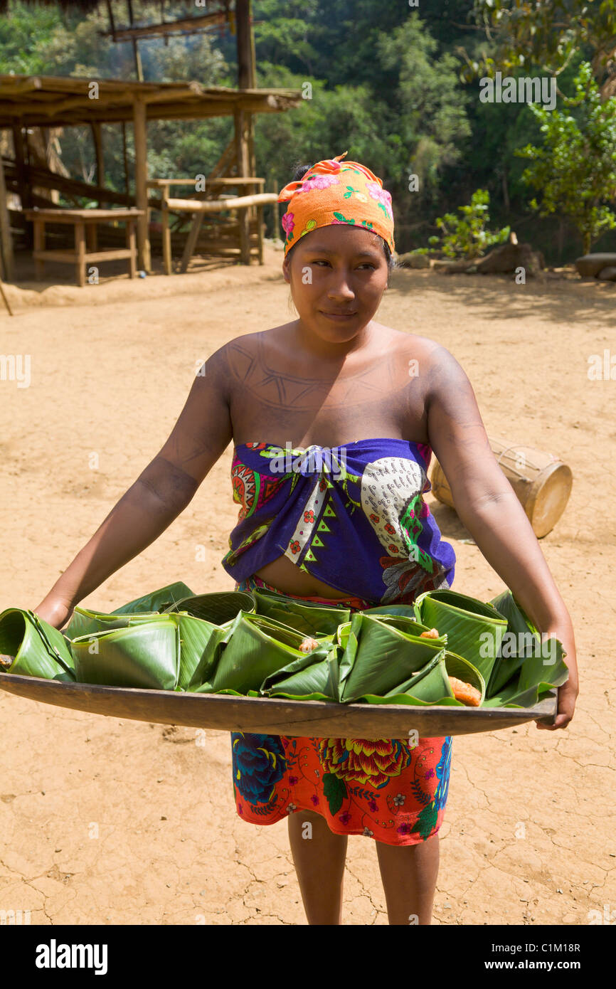 Woman of the Native Indian Embera Tribe offering a local dish, Embera ...