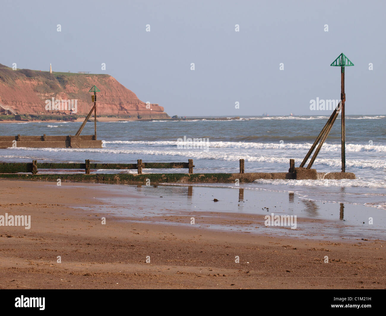 Groynes sea defenses Exmouth, Devon with Orcombe point in the ...