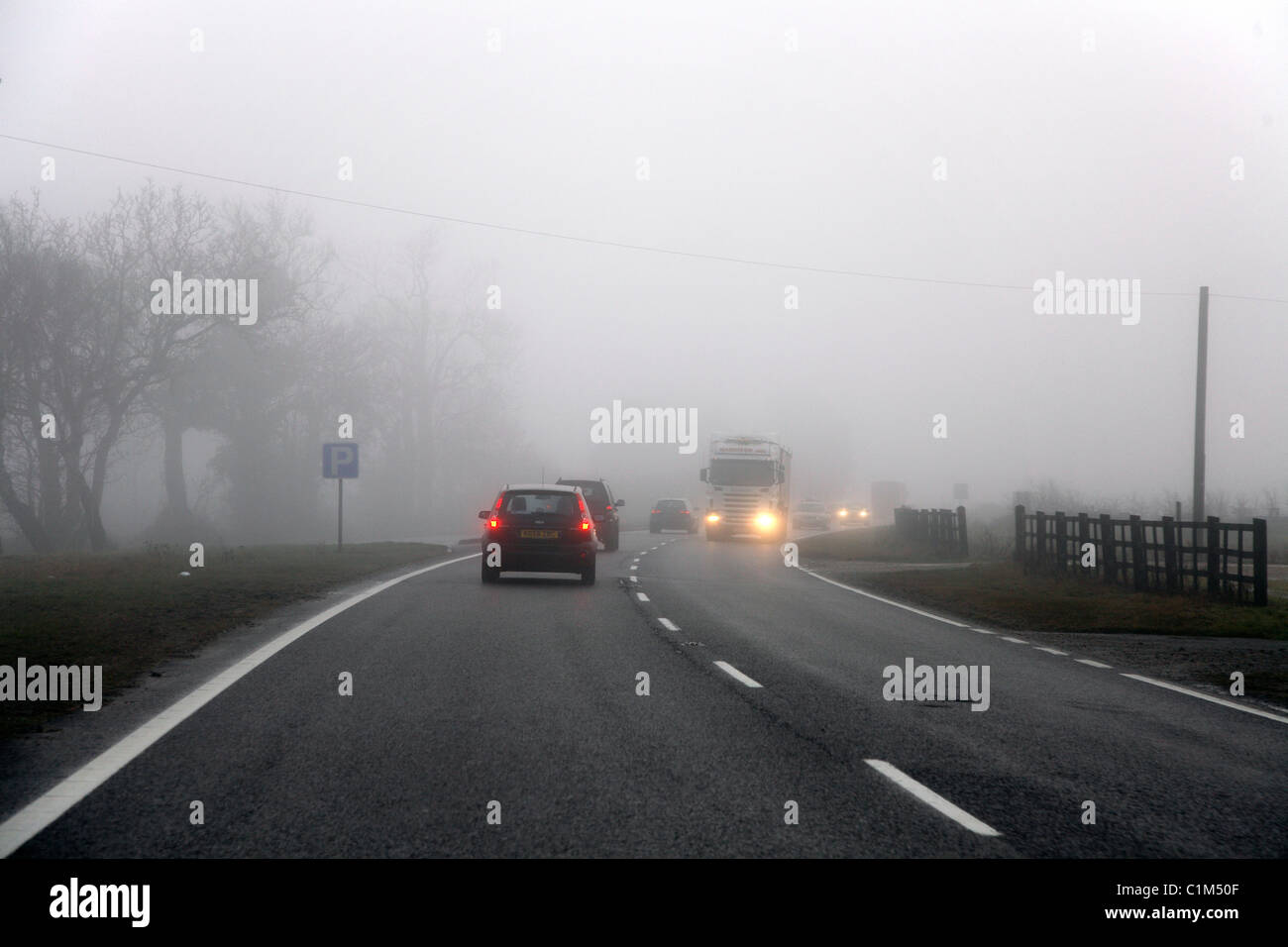 Cars driving in fog Stock Photo - Alamy