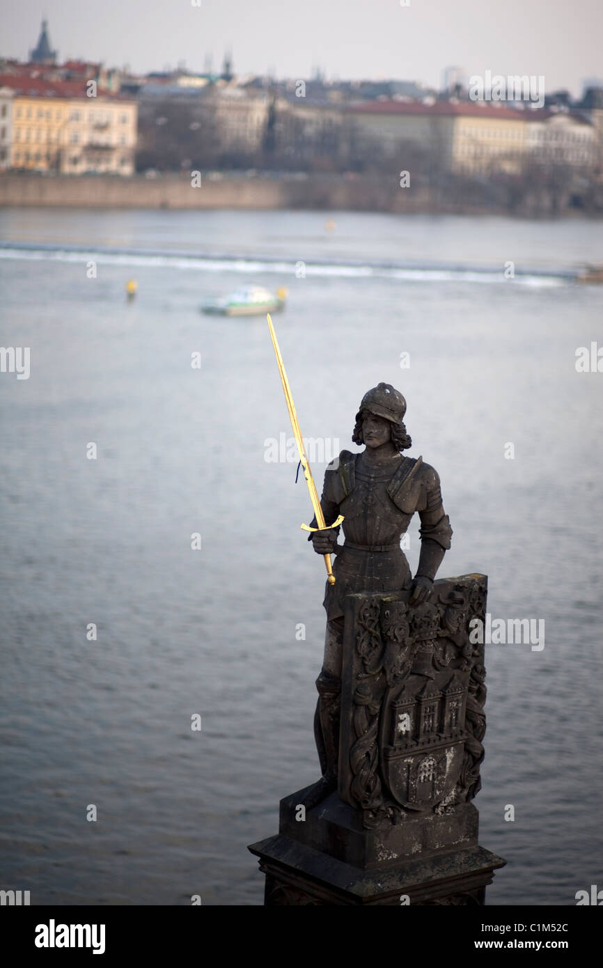 Statue on the Charles (Karlov) bridge in Prague with the city scape ...