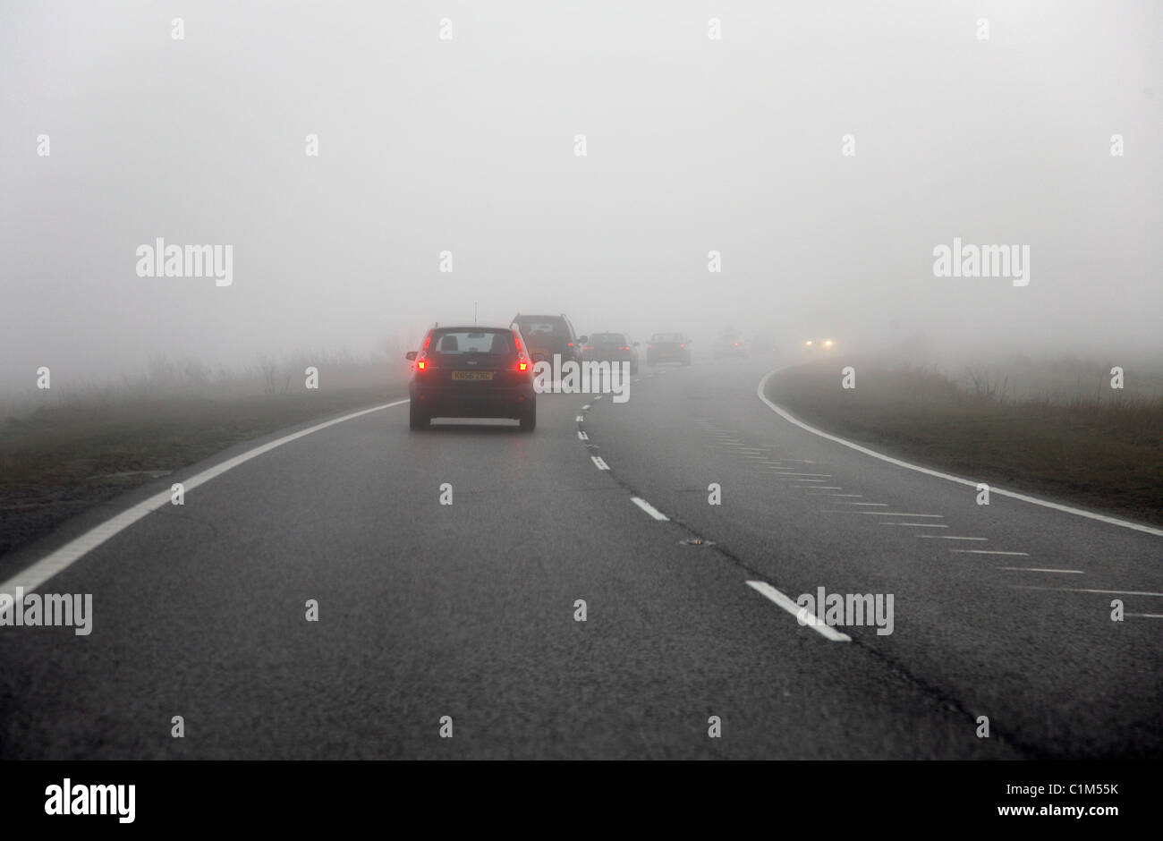Cars driving in fog Stock Photo - Alamy