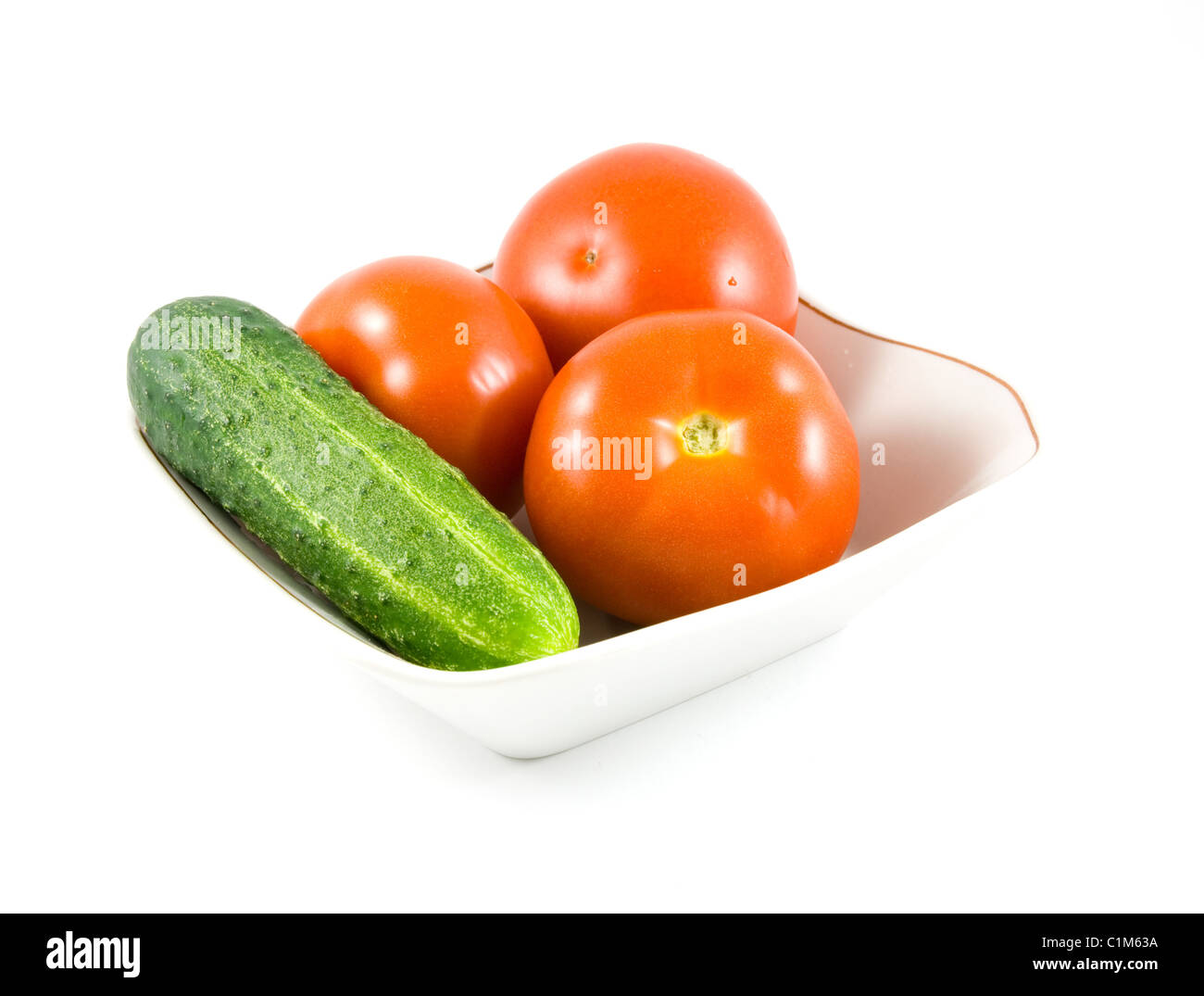 Vegetables - three tomatoes and cucumber Stock Photo - Alamy