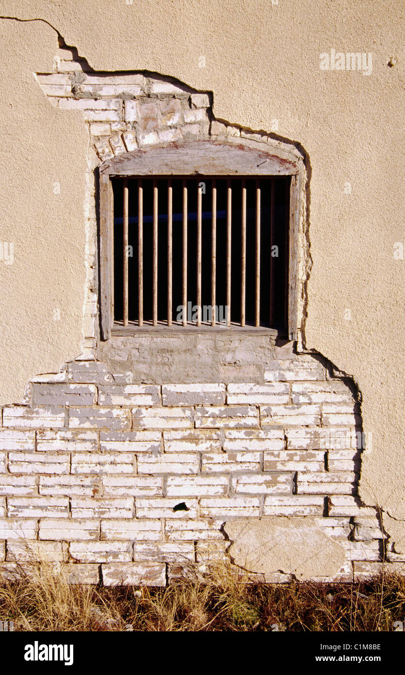 Cracking stucco reveals the older adobe construction around this window ...