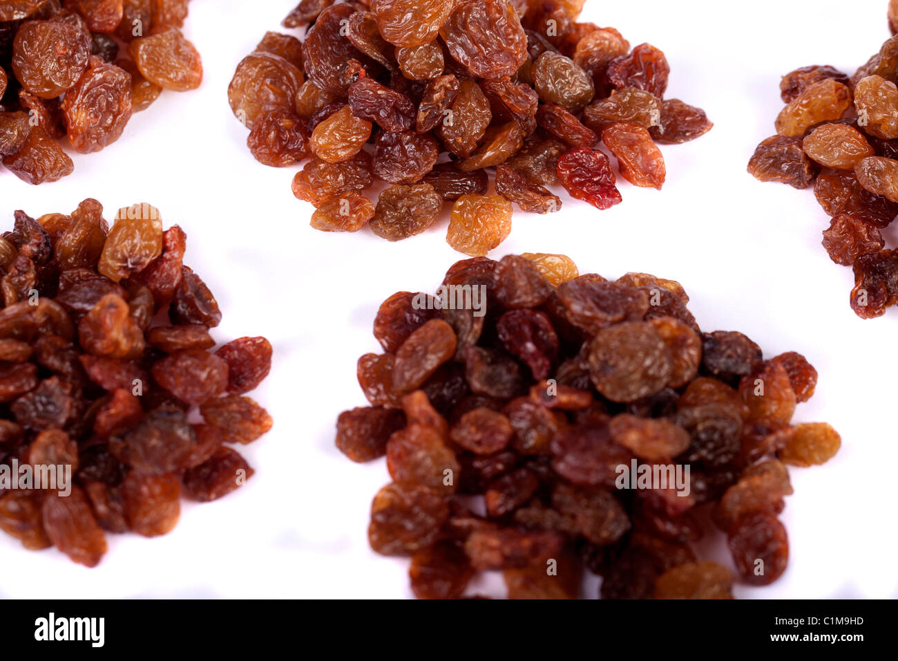 Close view of a pile of dry raisins isolated on a white background ...