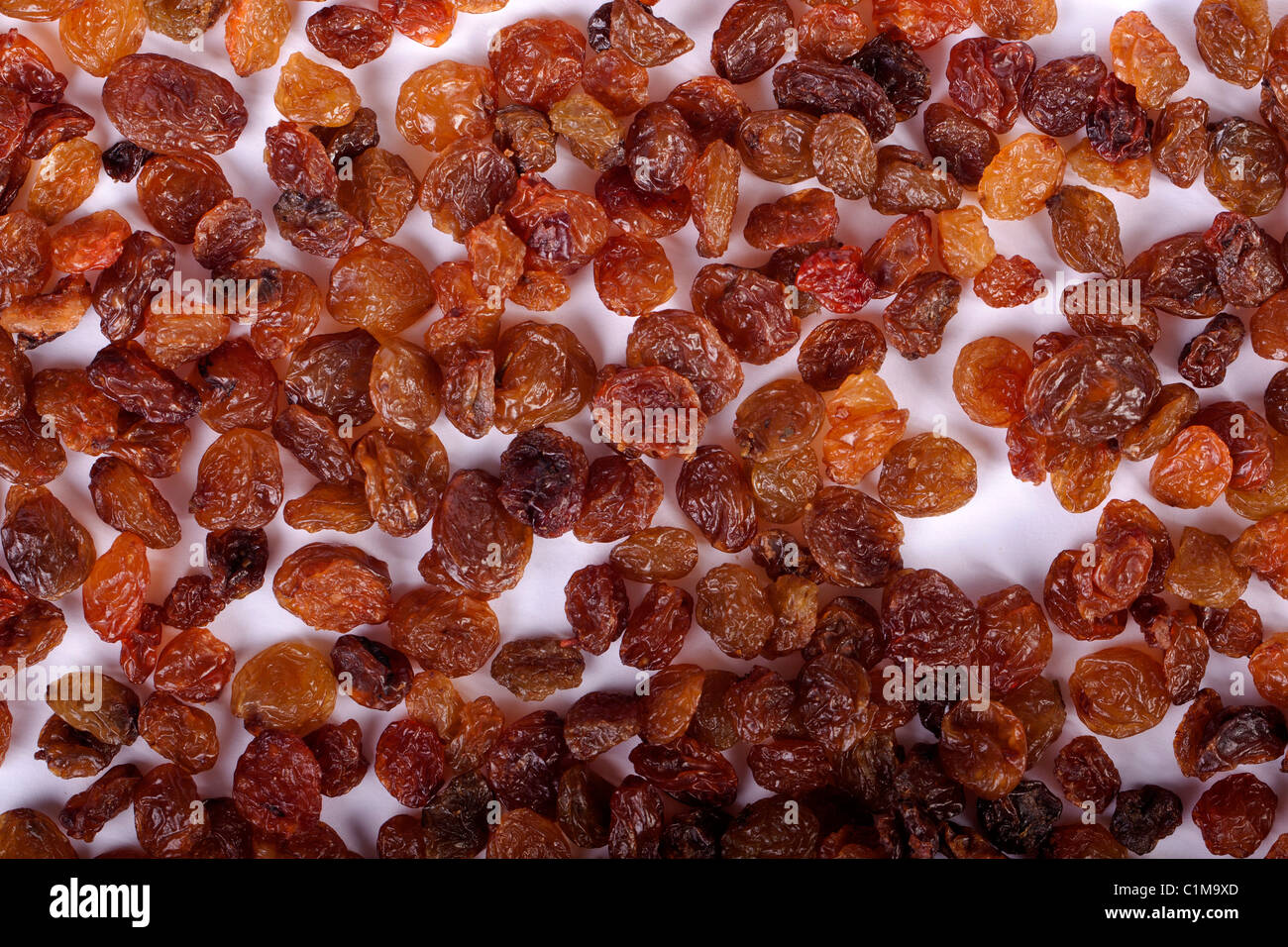 Close view of a pile of dry raisins isolated on a white background ...
