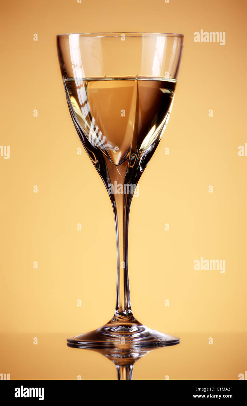 glass of white wine on yellow background Stock Photo - Alamy