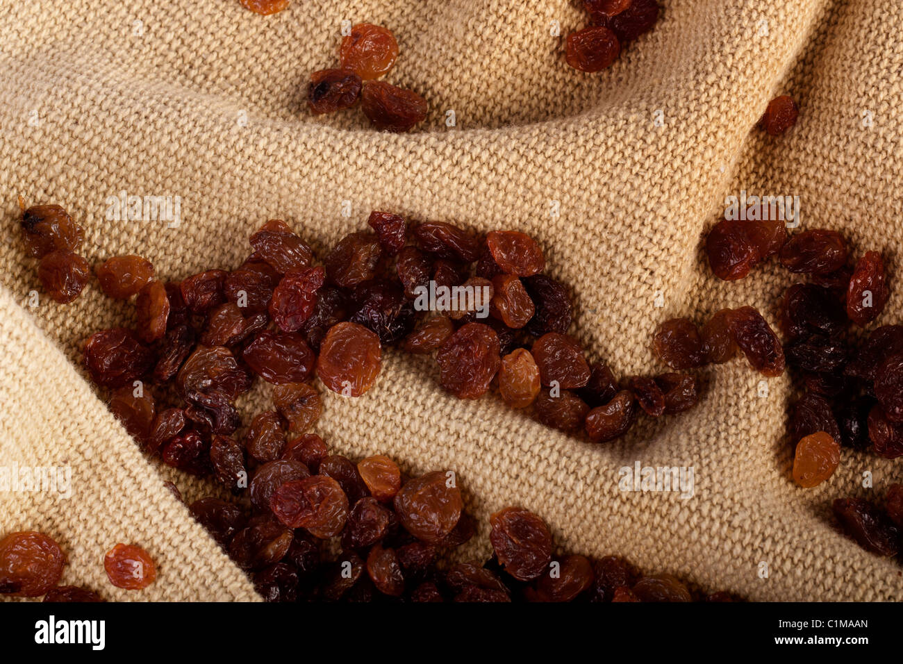 View of a bunch of dry raisins scattered on a cloth Stock Photo - Alamy