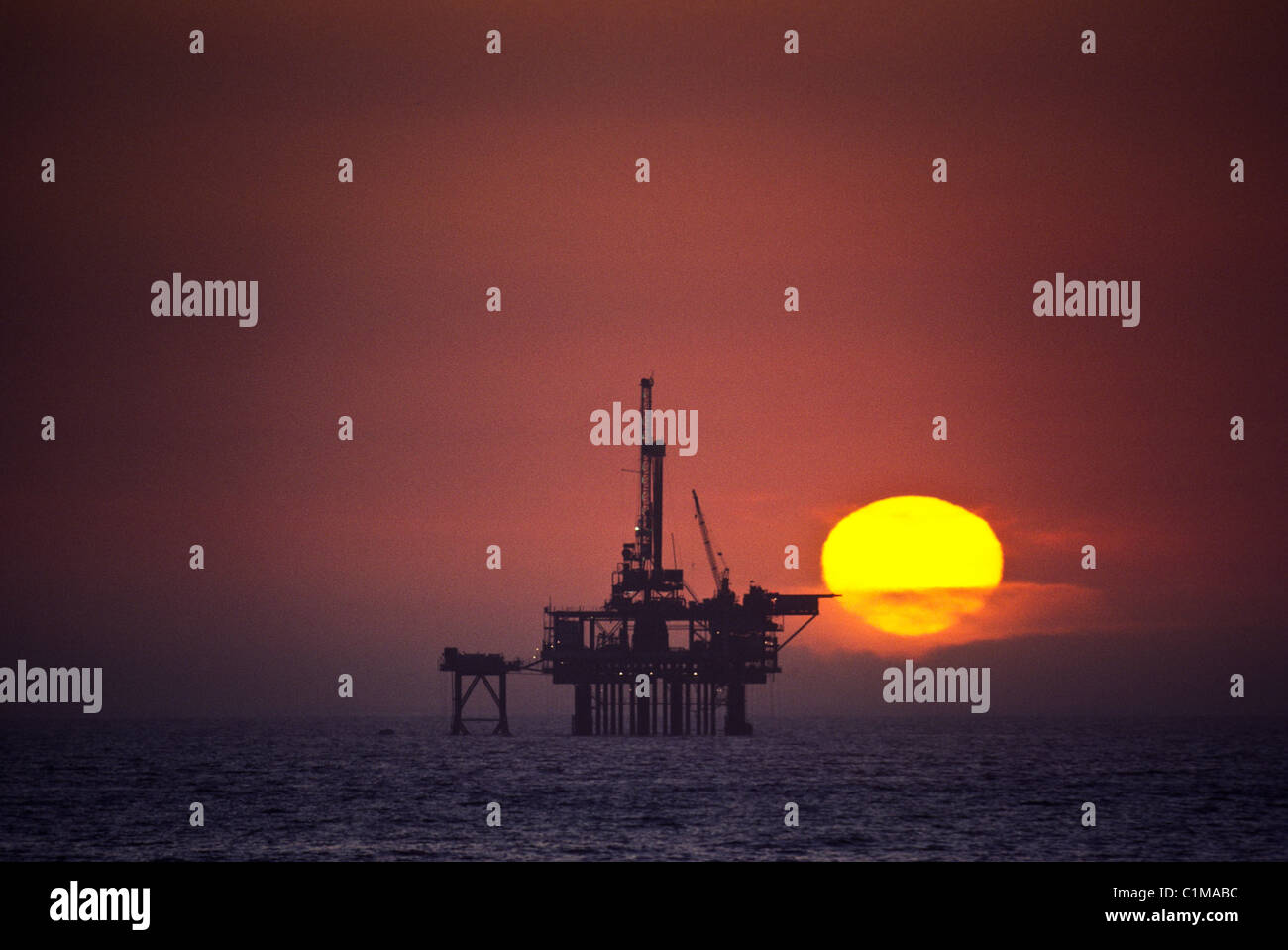 Offshore drilling rig at sunset off the coast of California in the ...