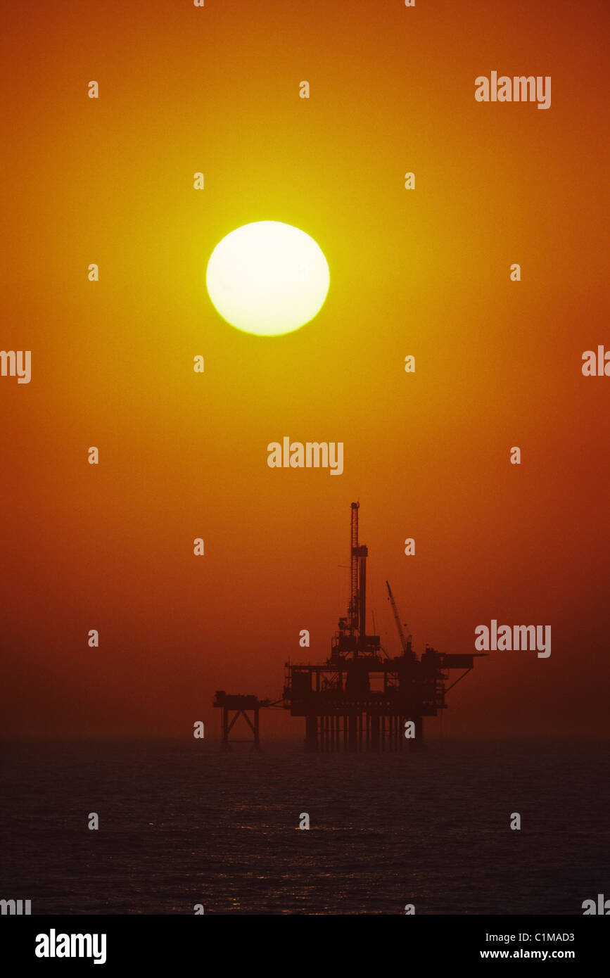 Offshore drilling rig at sunset off the coast of California in the ...