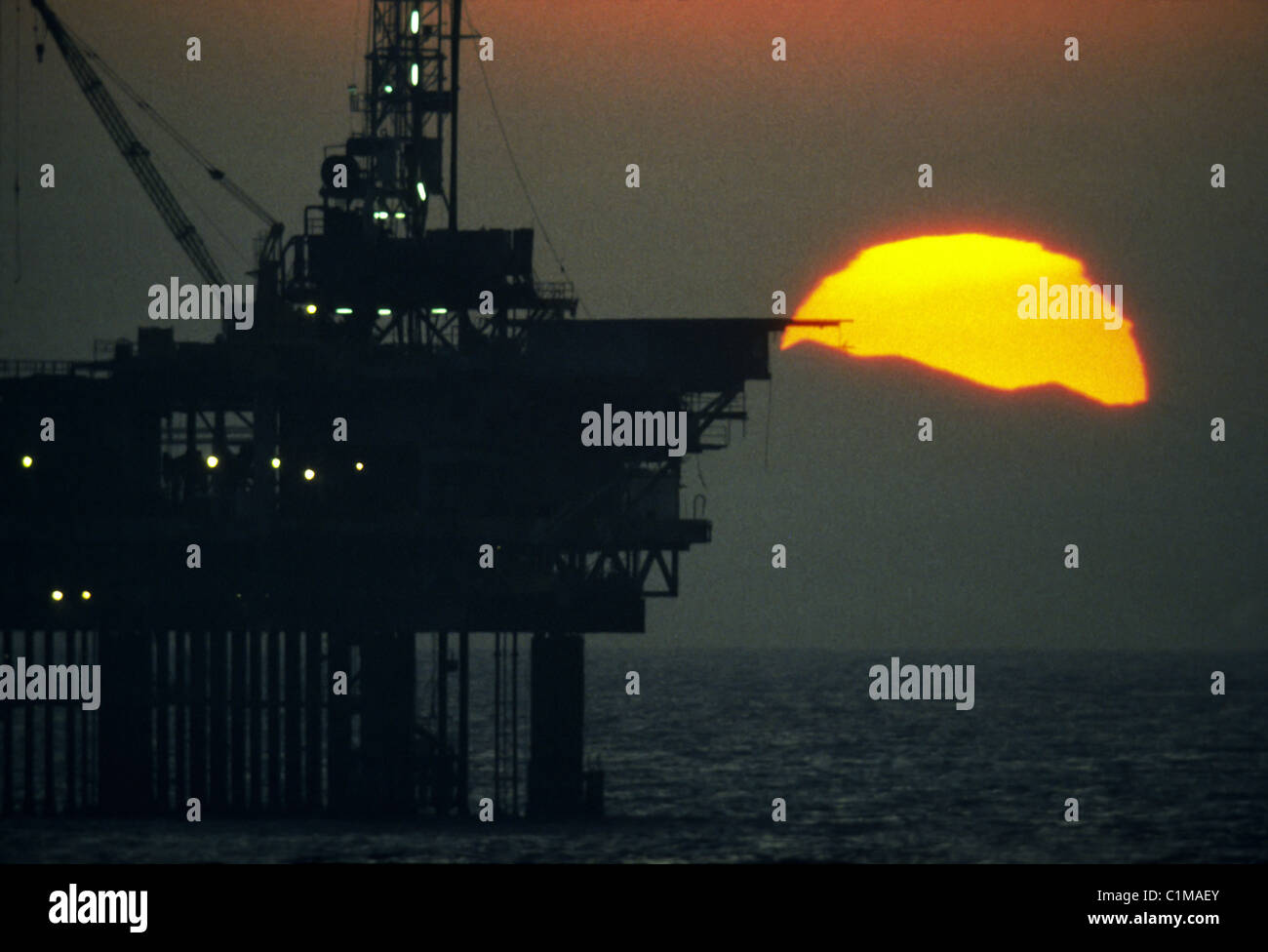 Offshore drilling rig at sunset off the coast of California in the ...