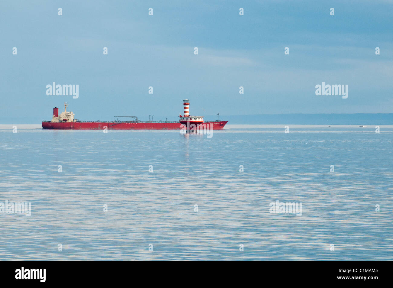 Oil tanker and lighthouse on St. Lawrence River near Tadoussac, Quebec ...