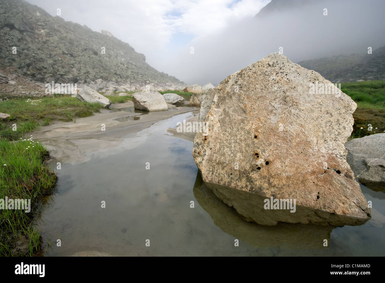 Boulders in water. Fog. Valley in East Sayan mountains. Siberia ...