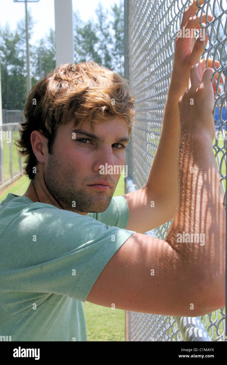 man against a fence Stock Photo - Alamy