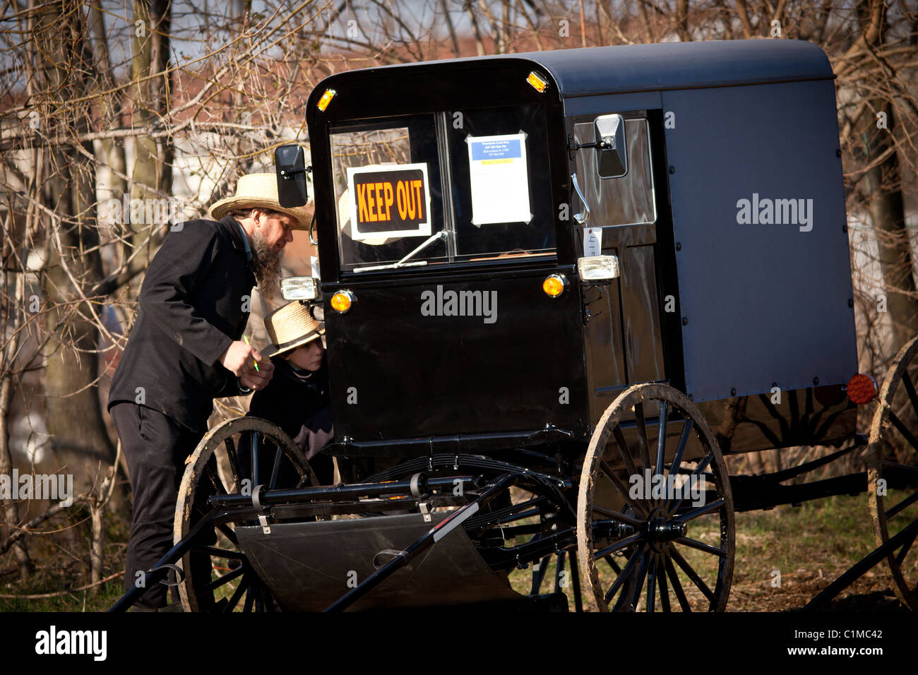 Amish family inspects a horse buggy during the Annual Mud Sale to ...