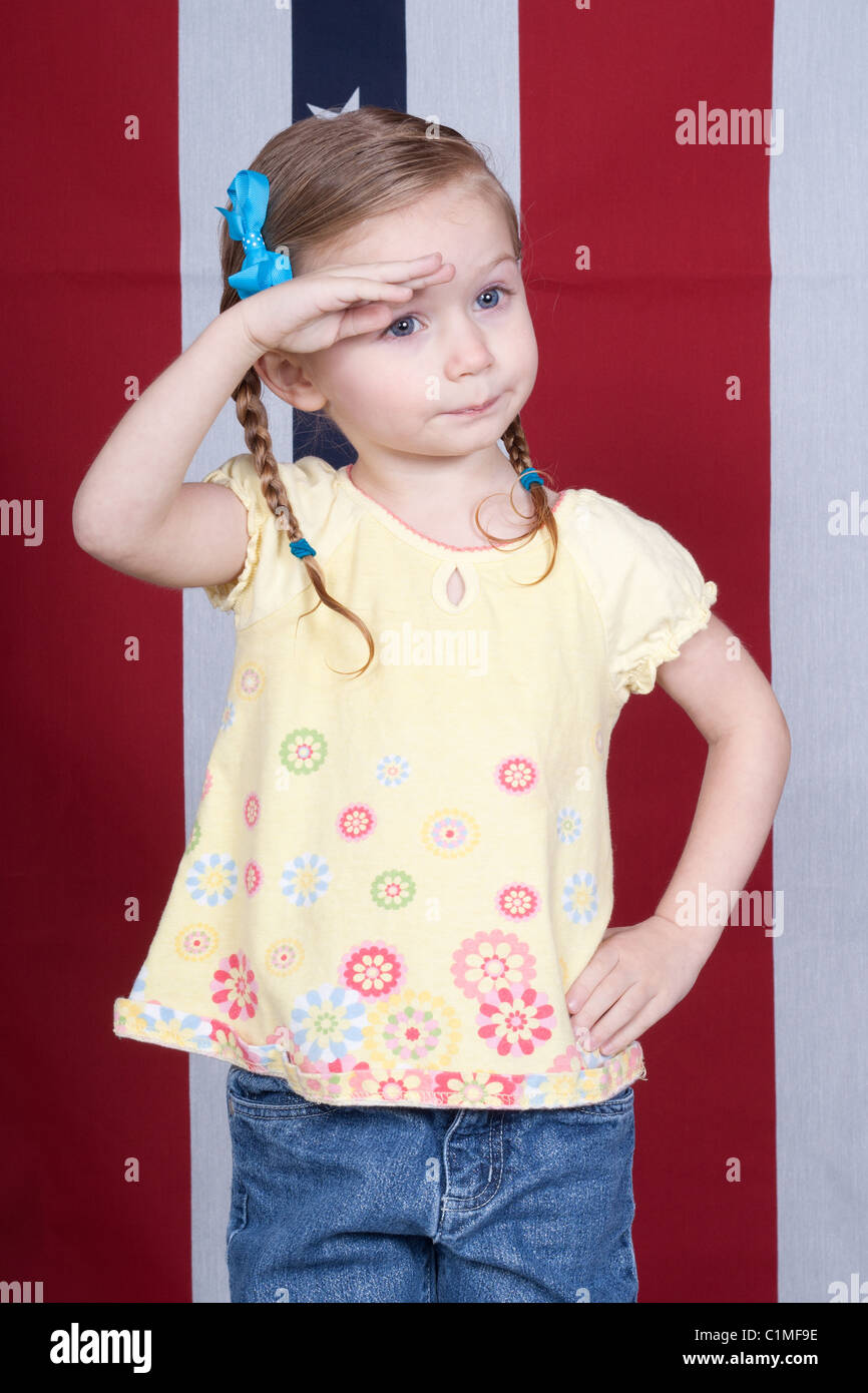 Cute girl saluting with a patriotic design in the background Stock ...
