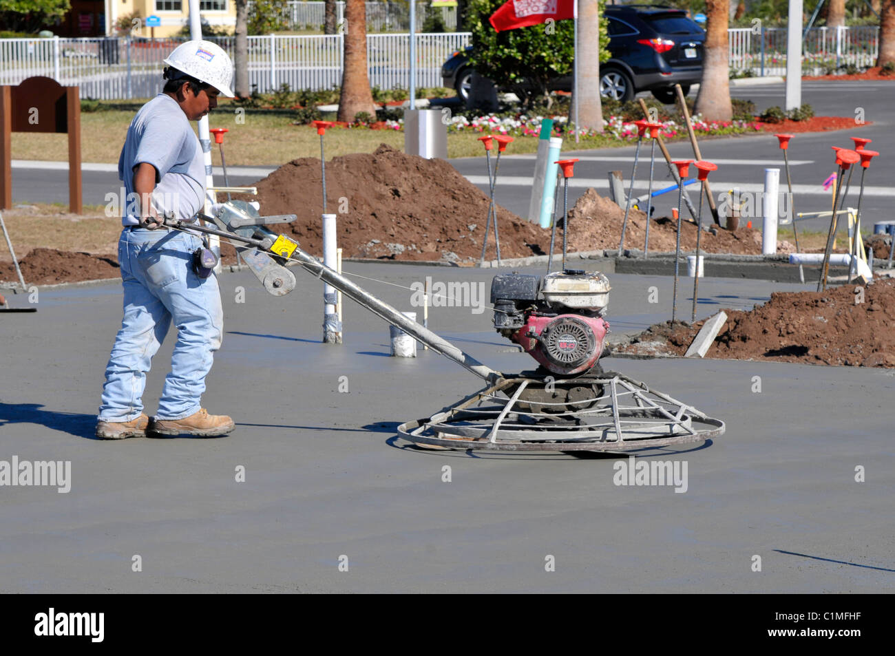 Latino hispanic Mason workers work to finish cement floor on new home ...
