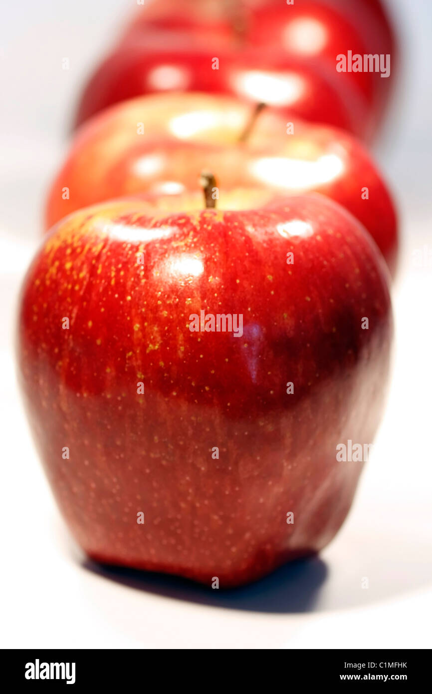 Bunch of red apples on a row isolated on a white background Stock Photo ...