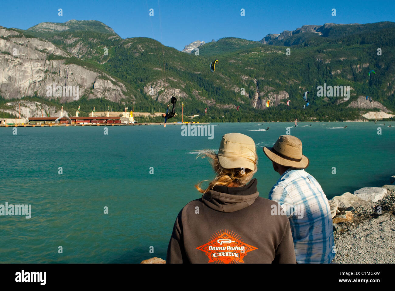 Spectators watch windsport athletes at "the Spit", Squamish, BC, Canada ...