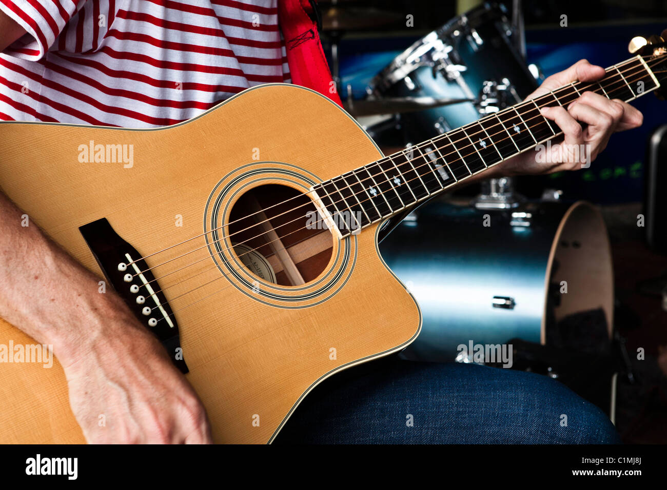 A man playing an acoustic guitar Stock Photo - Alamy