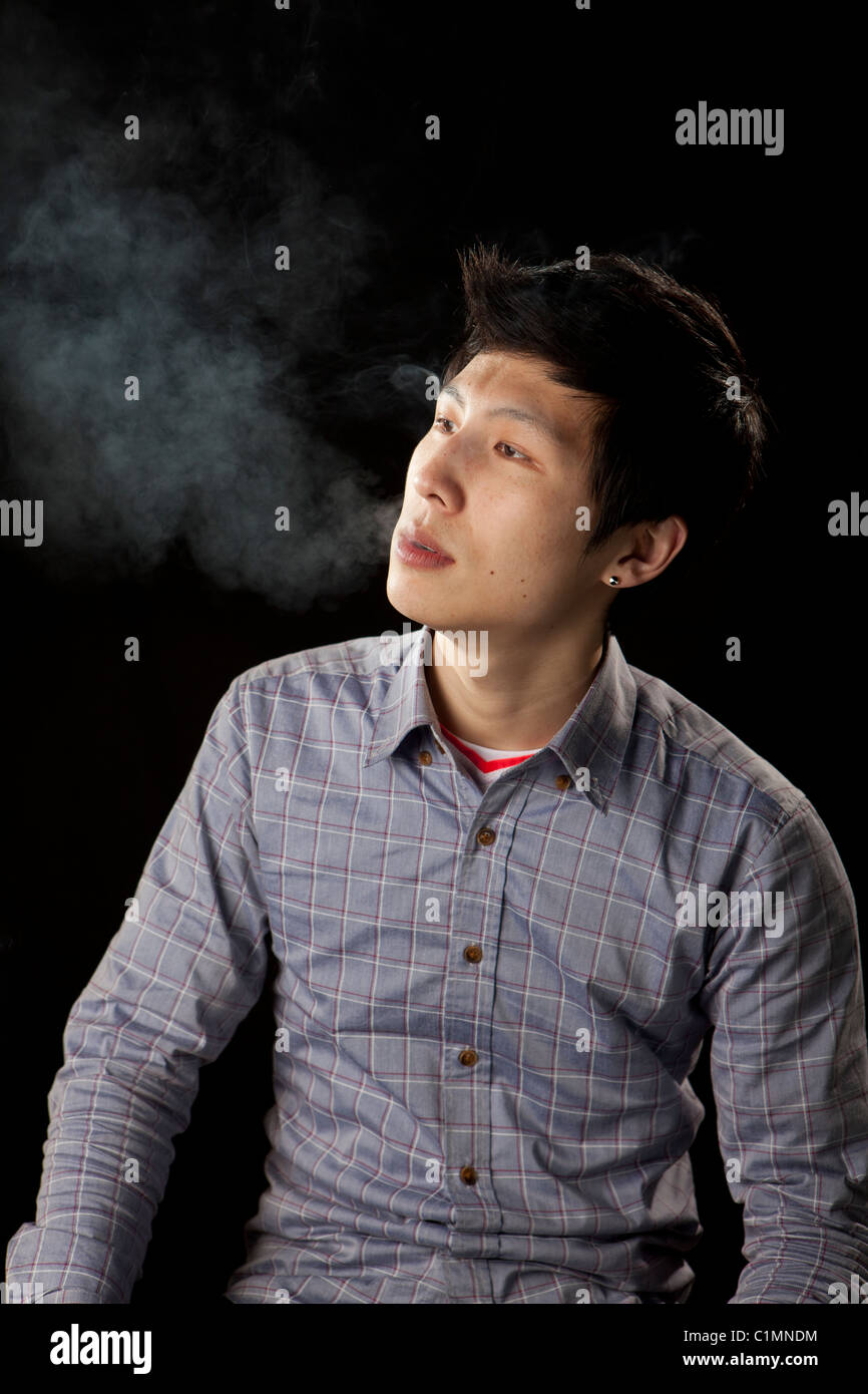 University student reading book with smoking cigarette Stock Photo - Alamy