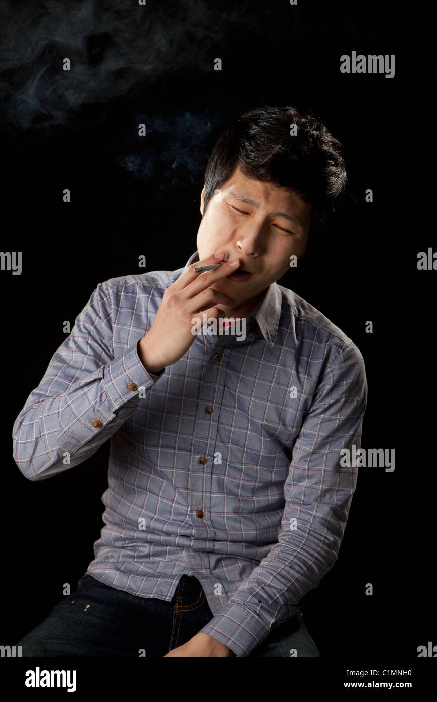 University student reading book with smoking cigarette Stock Photo - Alamy