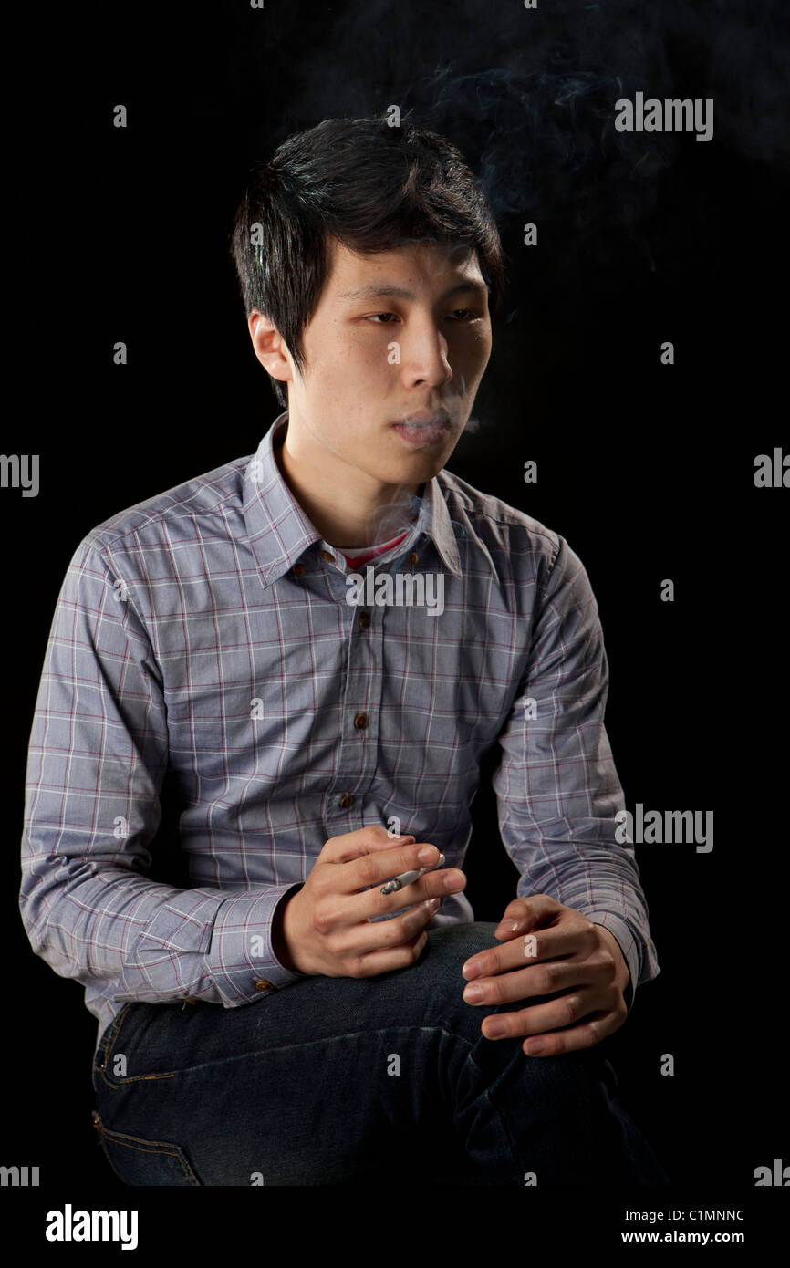 University student reading book with smoking cigarette Stock Photo - Alamy