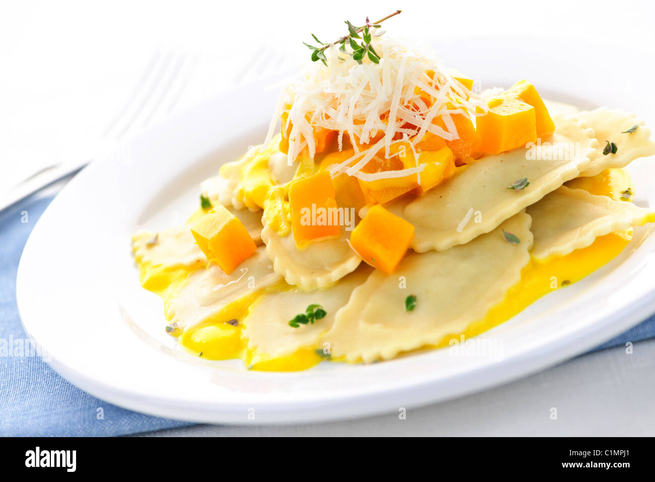 Gourmet squash ravioli dinner served with cheese on plate Stock Photo ...