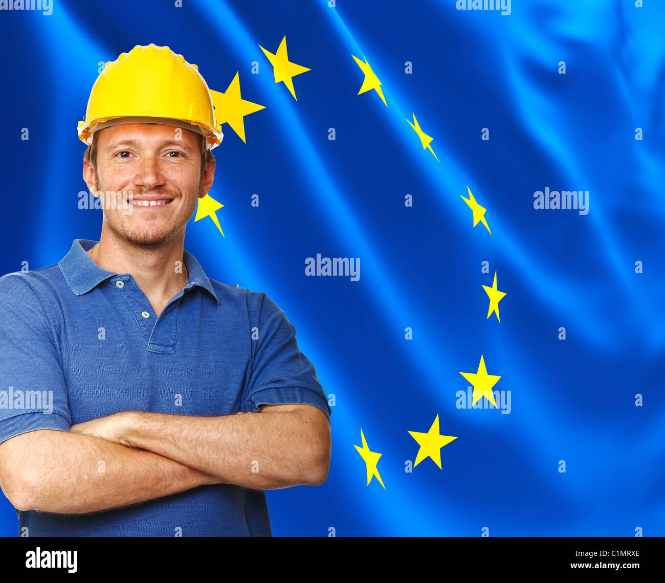 smiling caucasian worker and european flag background Stock Photo - Alamy