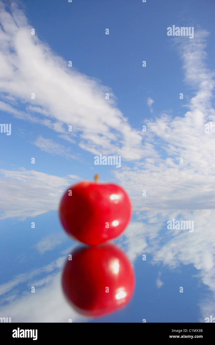 red blur apple on the mirror and sky Stock Photo - Alamy