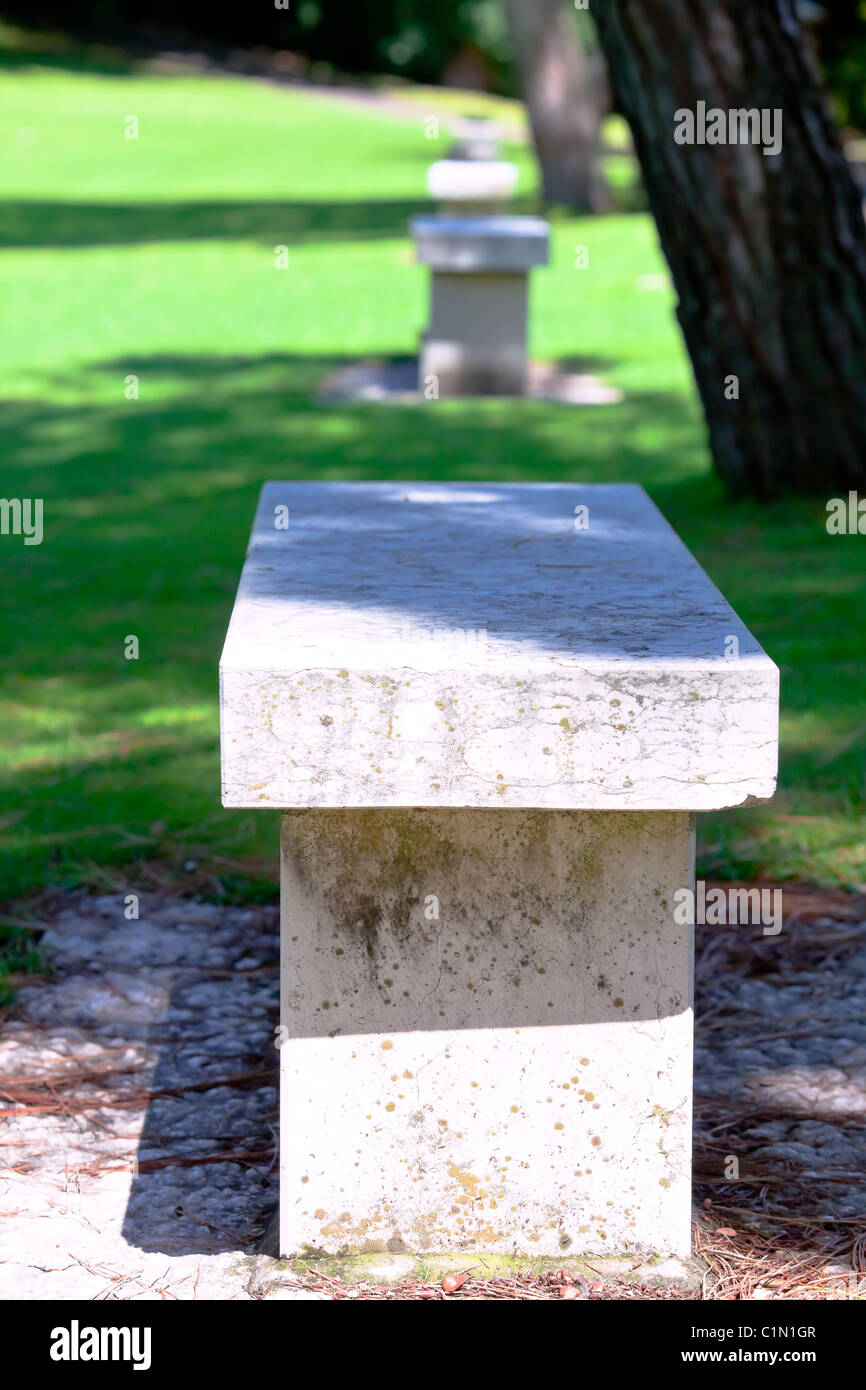 White stone benches row in a park. Vertical shot Stock Photo - Alamy