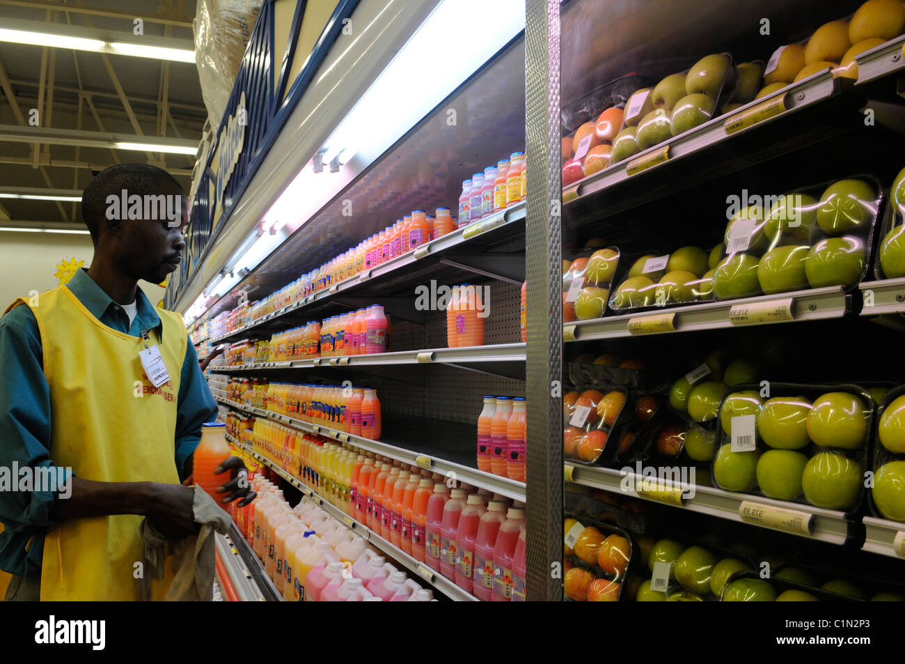 Worker stocking shelves in a supermarket, Lilongwe capital of Malawi ...