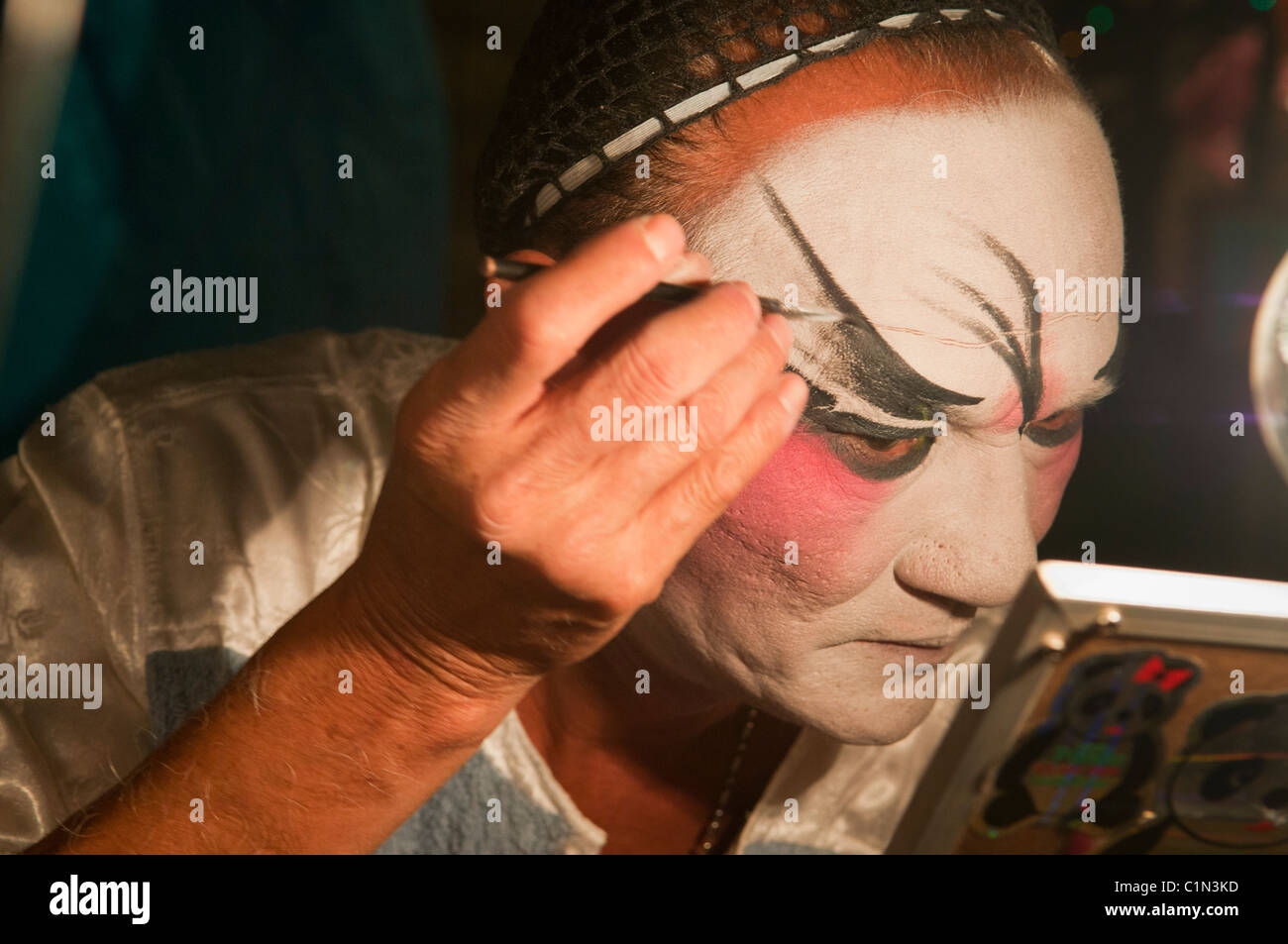 Chinese opera performer applies makeup backstage in Bangkok, Thailand ...