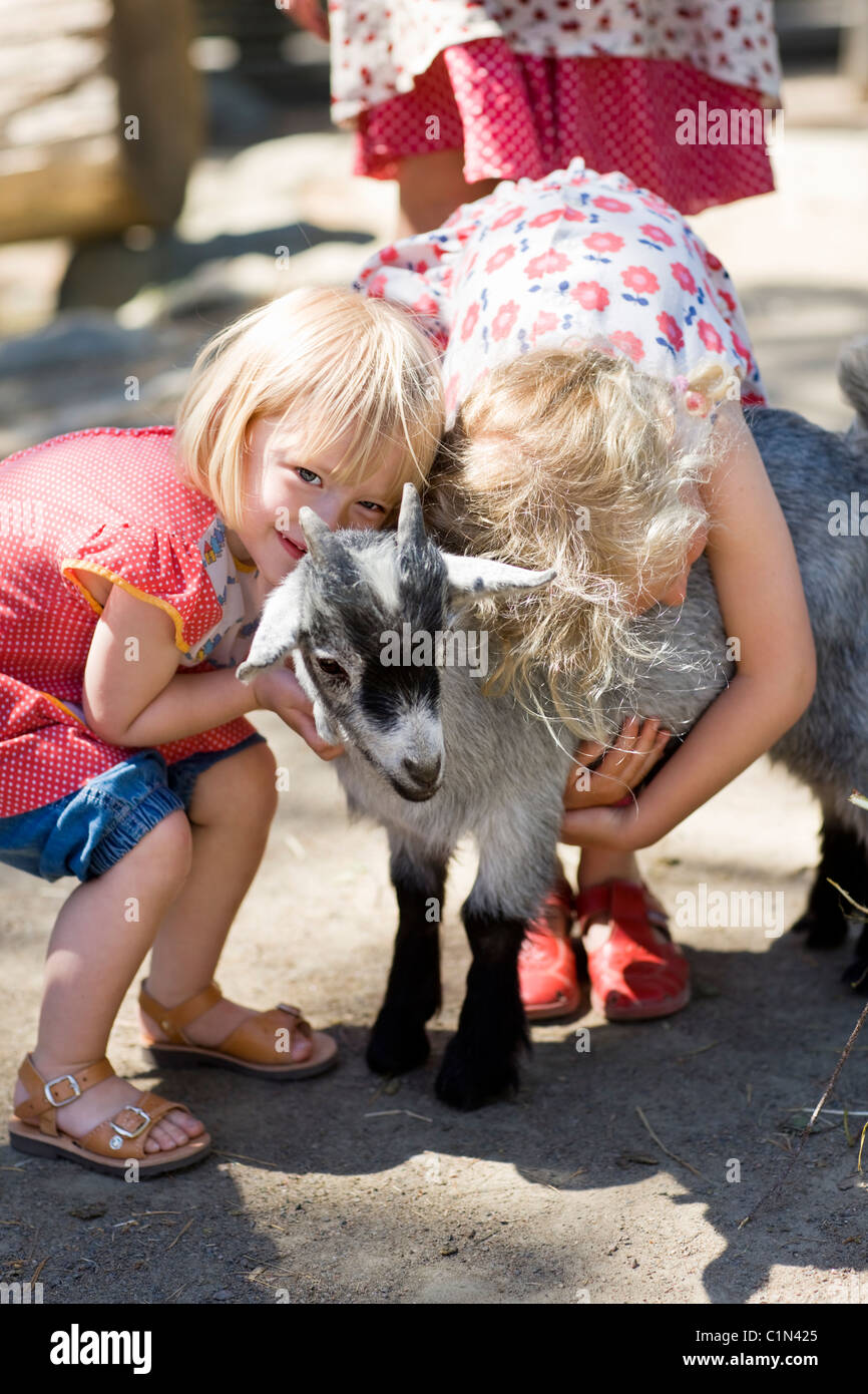 Girl embracing goat at zoo Stock Photo - Alamy