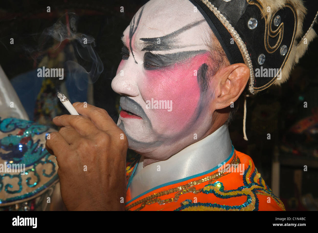 Chinese opera performer smoking backstage in Bangkok, Thailand Stock ...