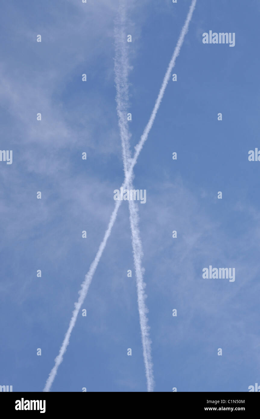 Crossed jet trails in the sky Stock Photo - Alamy