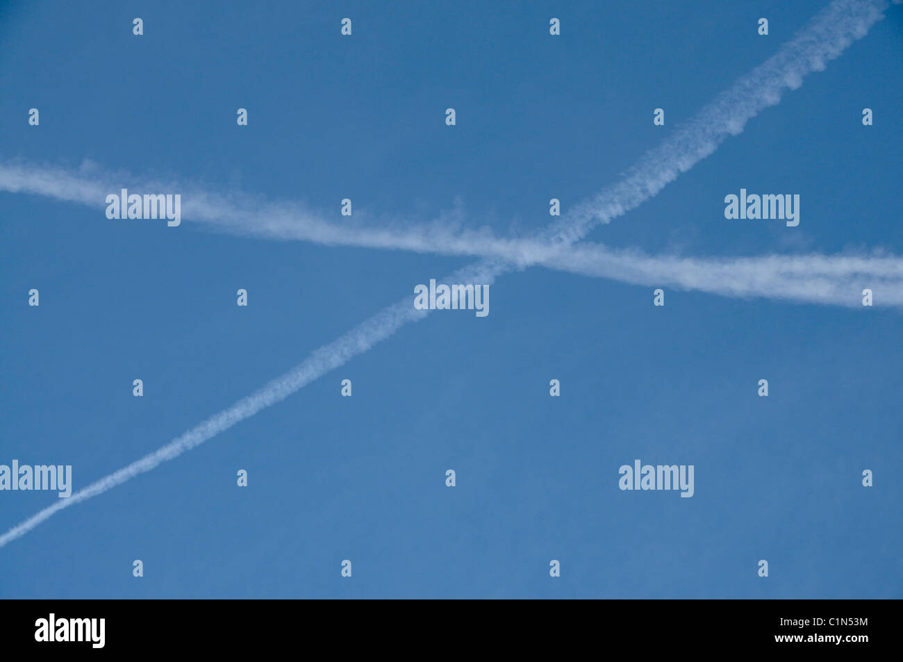 Crossed jet trails in the sky Stock Photo - Alamy
