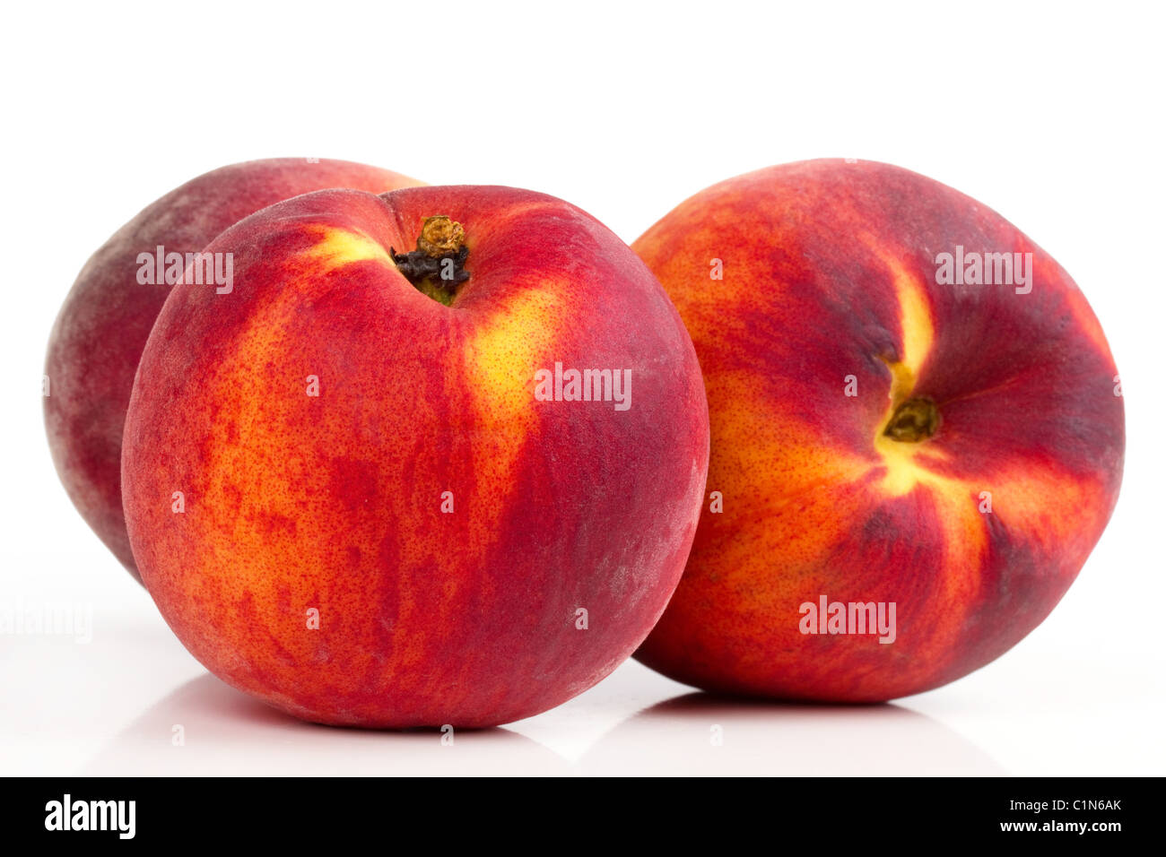 Three peaches on white table, closeup Stock Photo - Alamy