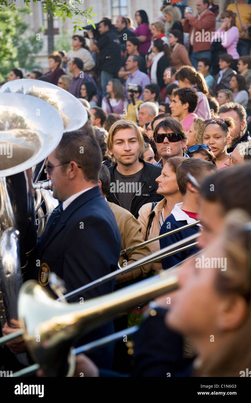 Spectator & brass band / bandsman / musician taking part / performing ...